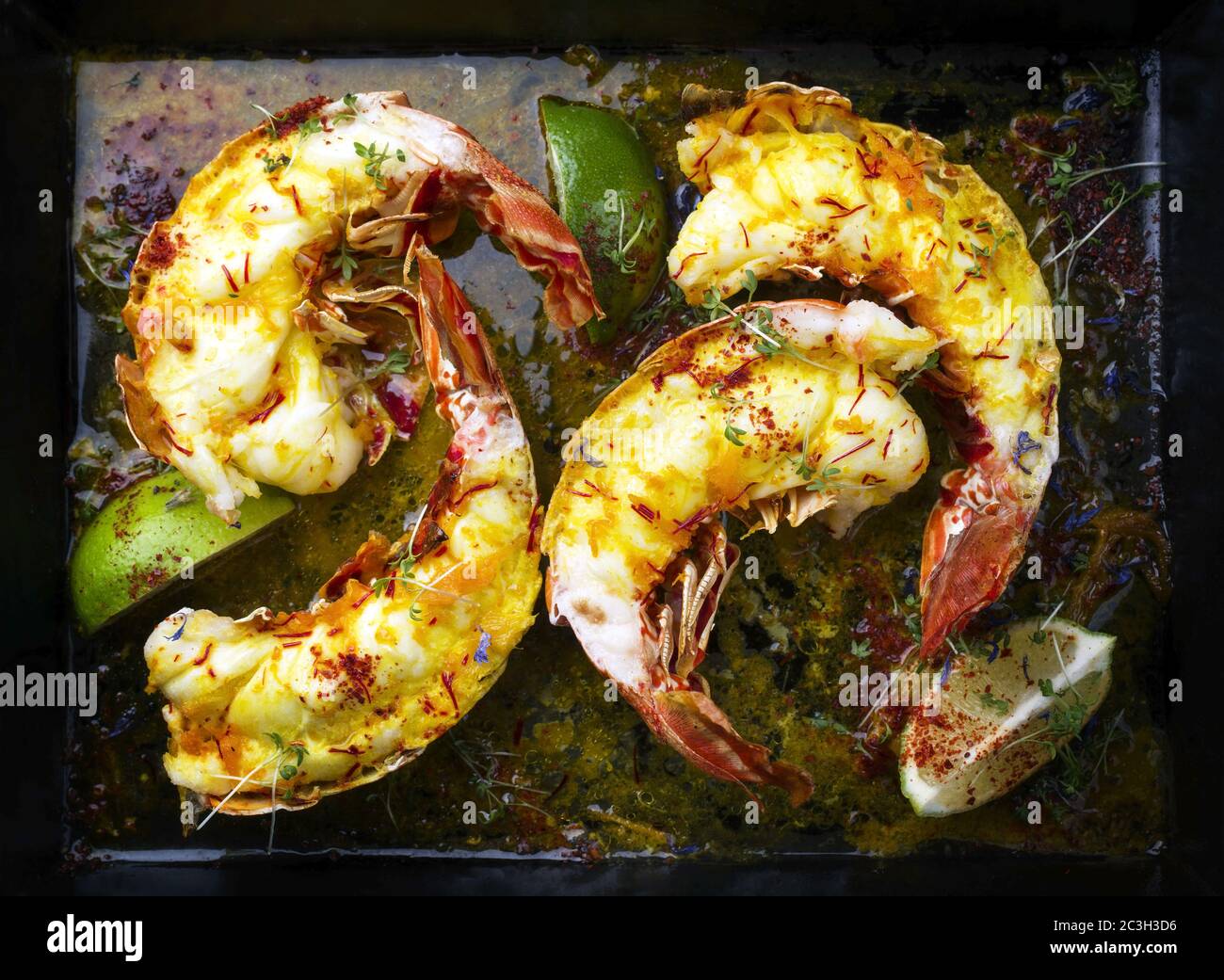 Traditional barbecue spiny lobster tail sliced and offered with saffron ...