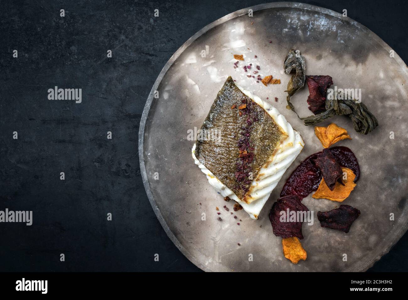 Gourmet fried European skrei cod fish filet with algae and vegetable ...