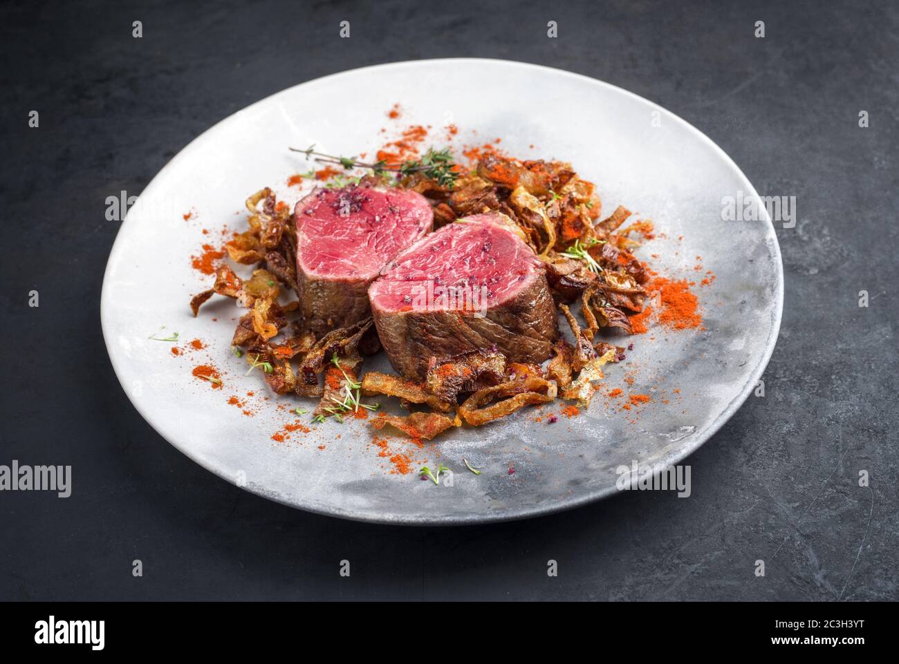 Barbecue dry aged beef fillet medallion steak natural with fried onion ...