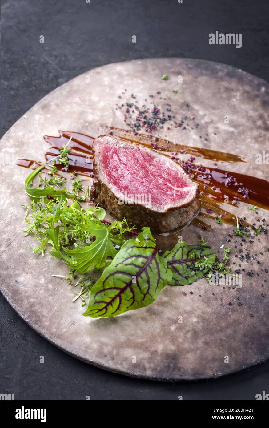 Fried dry aged beef fillet medallion steak natural with lettuce and ...