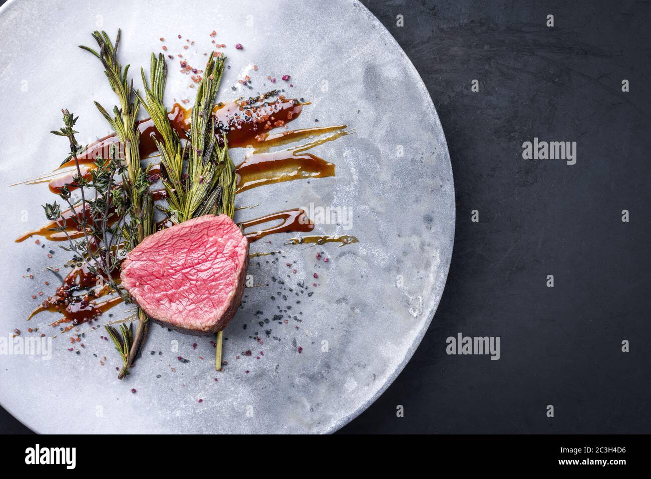 Barbecue dry aged beef fillet medallion steak natural with fried herbs ...