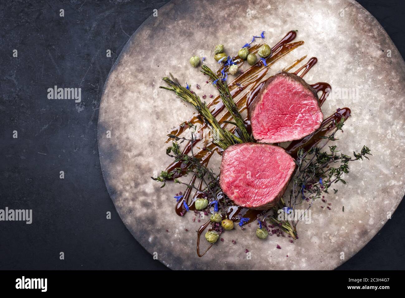Barbecue dry aged beef fillet medallion steak natural with fried herbs ...