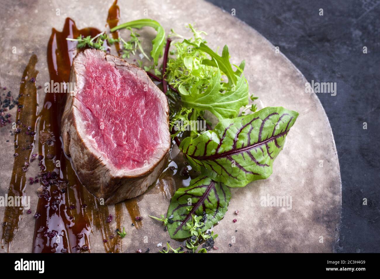Fried dry aged beef fillet medallion steak natural with lettuce and ...