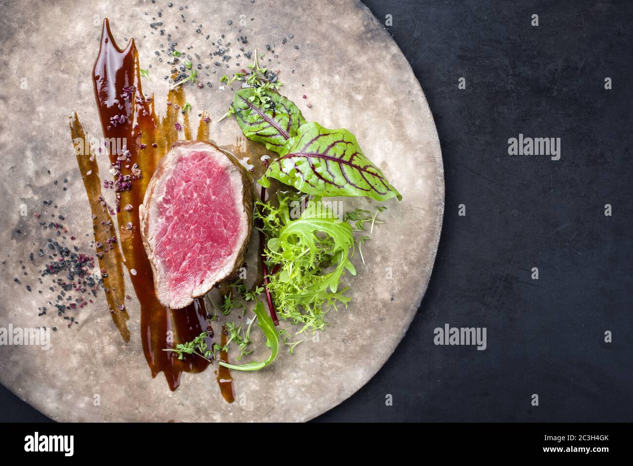 Fried dry aged beef fillet medallion steak natural with lettuce and ...