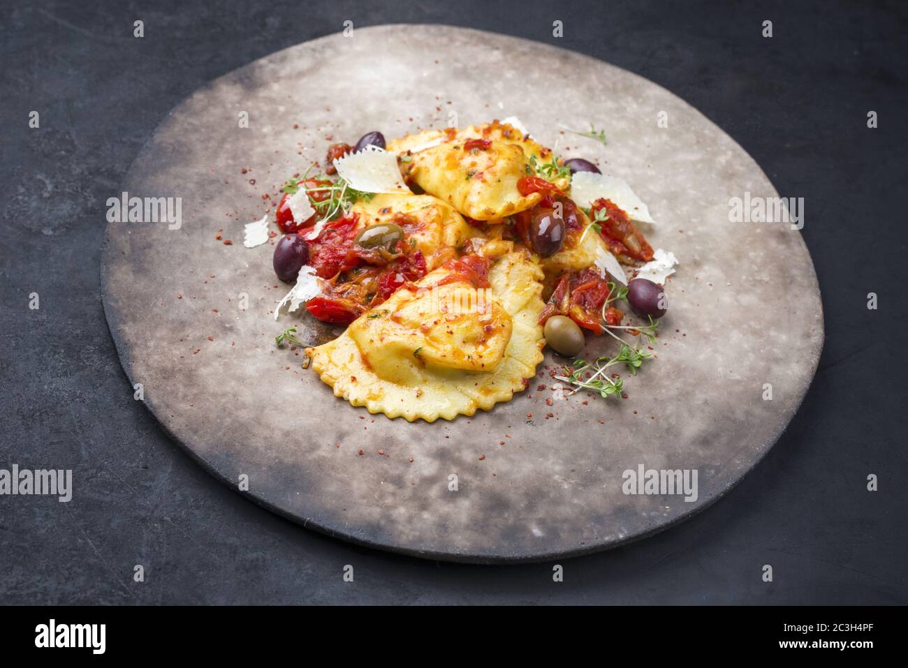 Traditional Italian ravioli pasta offered with parmesan cheese Stock ...