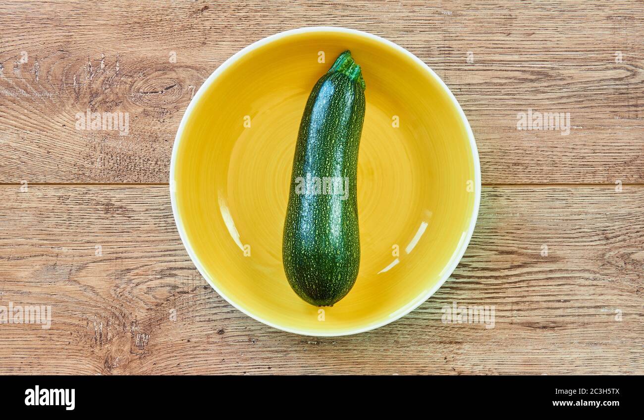 color still life - pale green zucchini squash with patterned skin on a ...