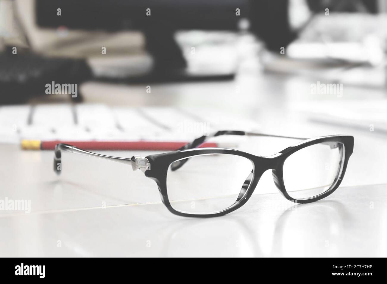 Eyeglasses on the desk Stock Photo - Alamy