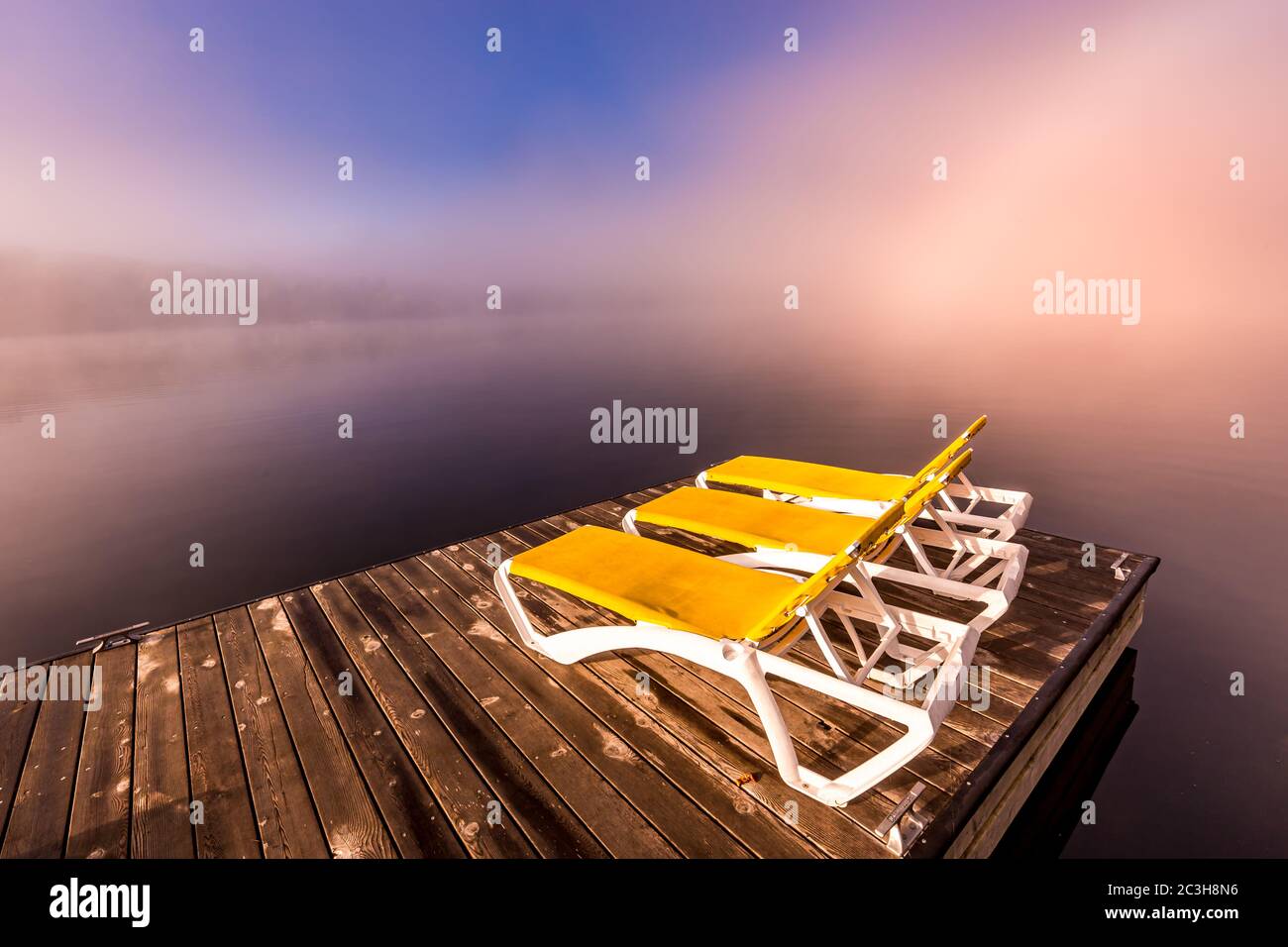 view of a boat dock the Lac-Superieur, misty morning with fog, in ...