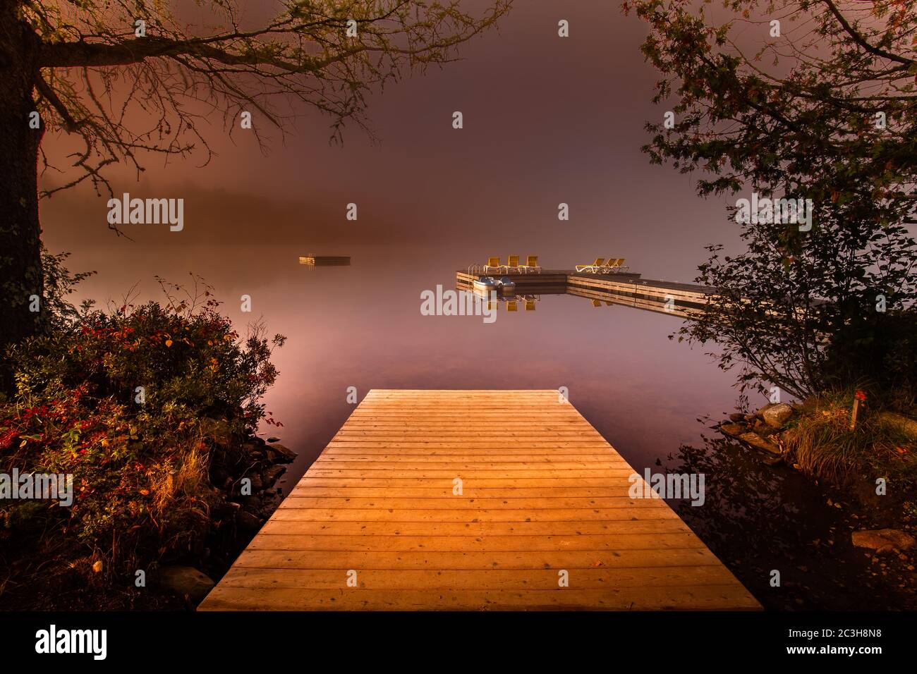 view of a boat dock the Lac-Superieur, misty morning with fog, in ...