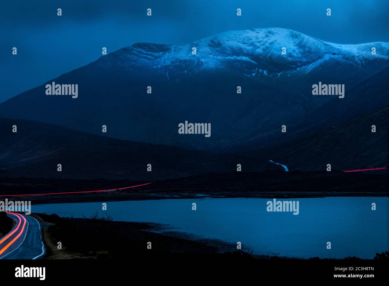 Driving at night under snow capped mountains on the Isle of Skye ...