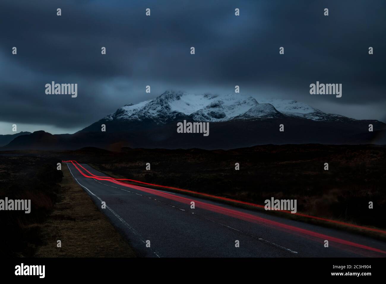 Driving at night under snow capped mountains on the Isle of Skye ...