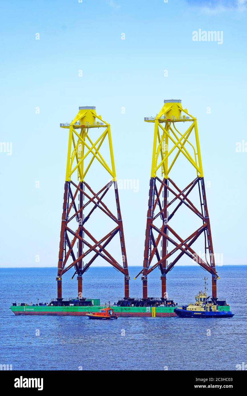 Multratugs towing 2 large completed wind turbine from Smulders yard ...