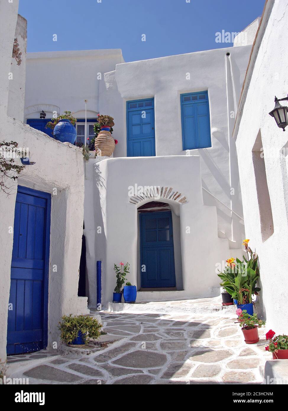 Traditional Greek village of whitewashed houses with blue windows and ...