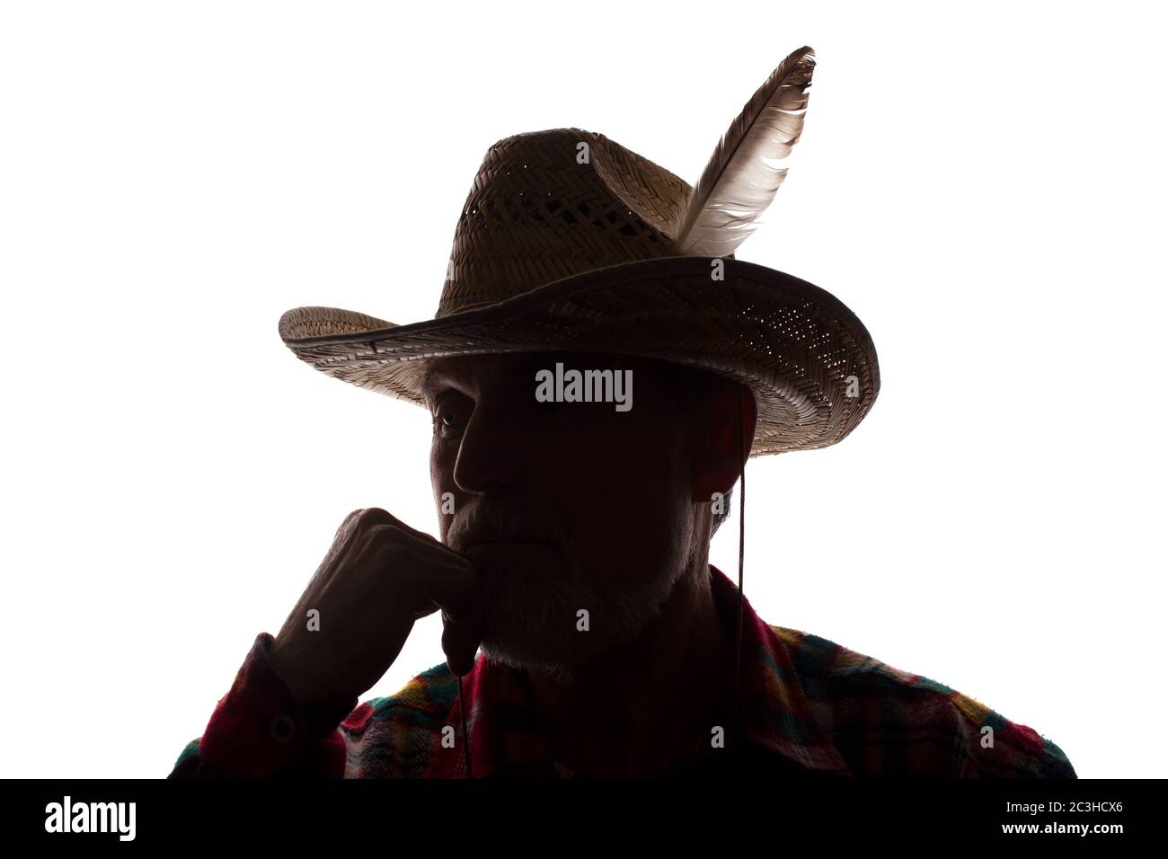 Portrait of pensive old man in a cowboy hat with a feather, with a ...