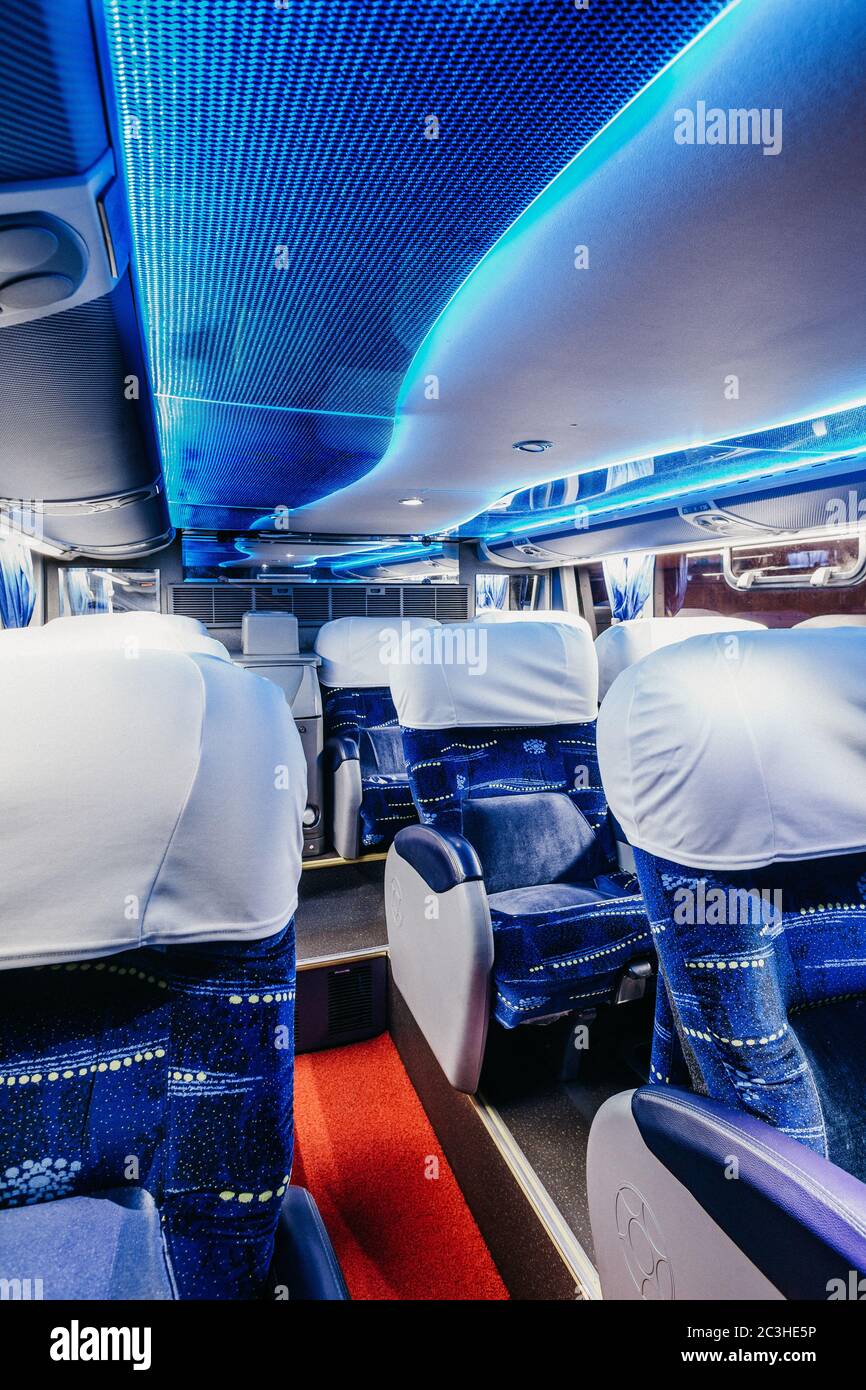 Vertical shot of an elegant car lounge with tables and neon walls Stock ...