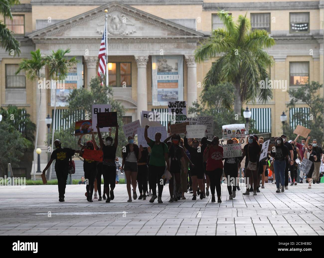 Palm Beach, FL, USA. 19th June, 2020. Protestors seen holding signs and ...