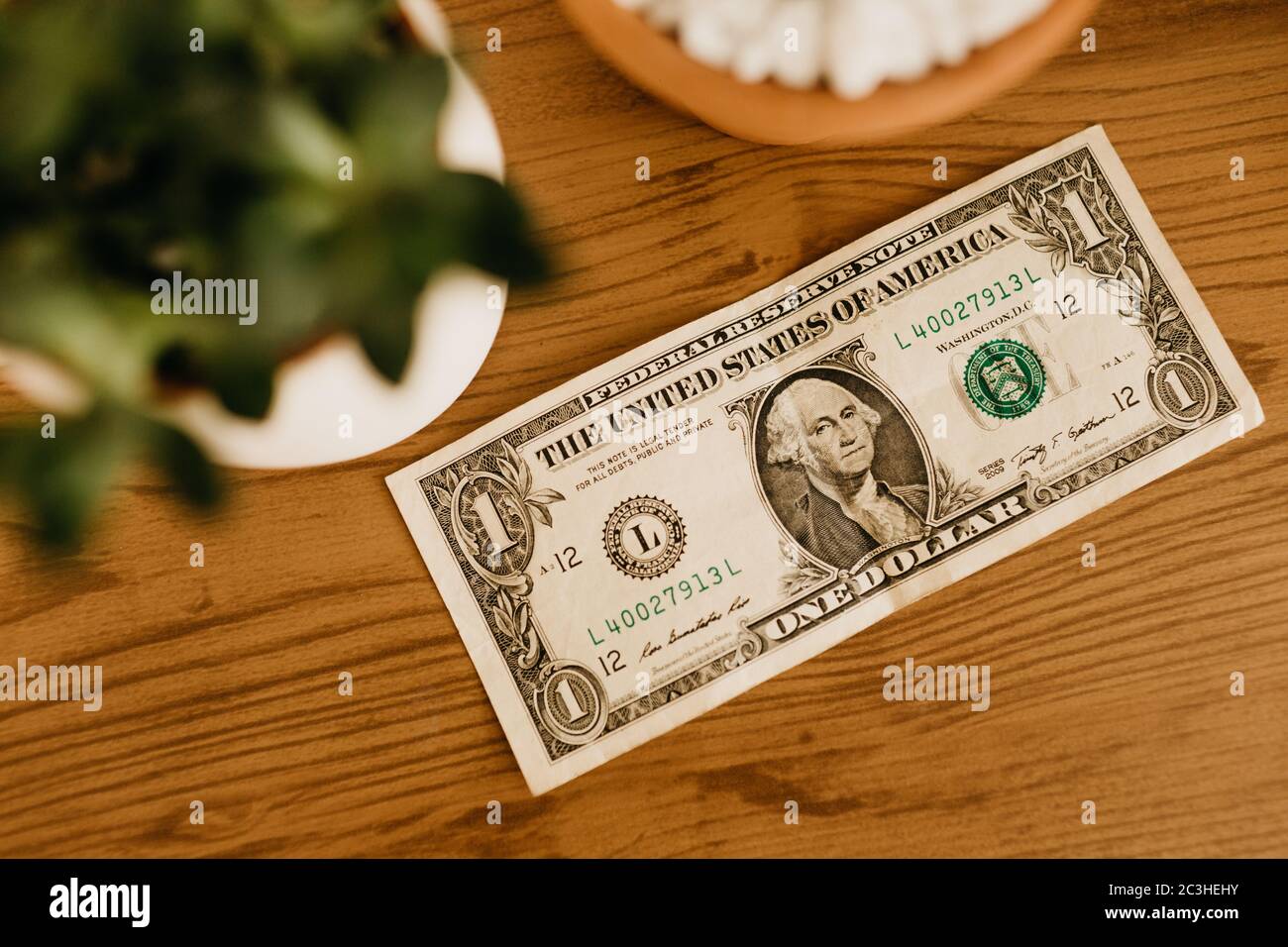 Top view of a one-dollar bill on a wooden table Stock Photo - Alamy