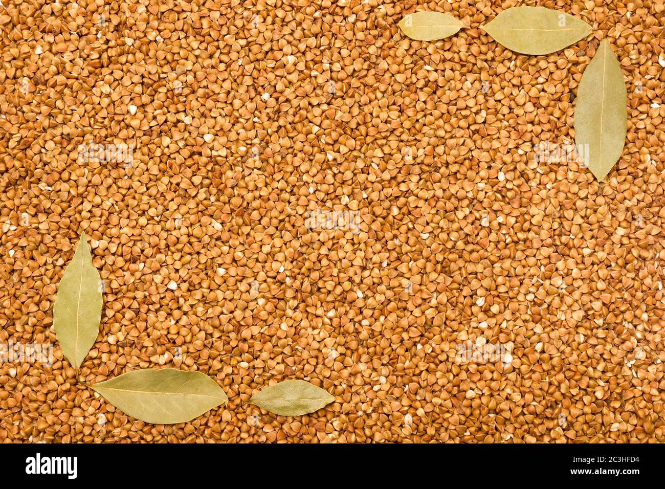 Dry buckwheat grains - brown texture, food ingredients with laurel ...