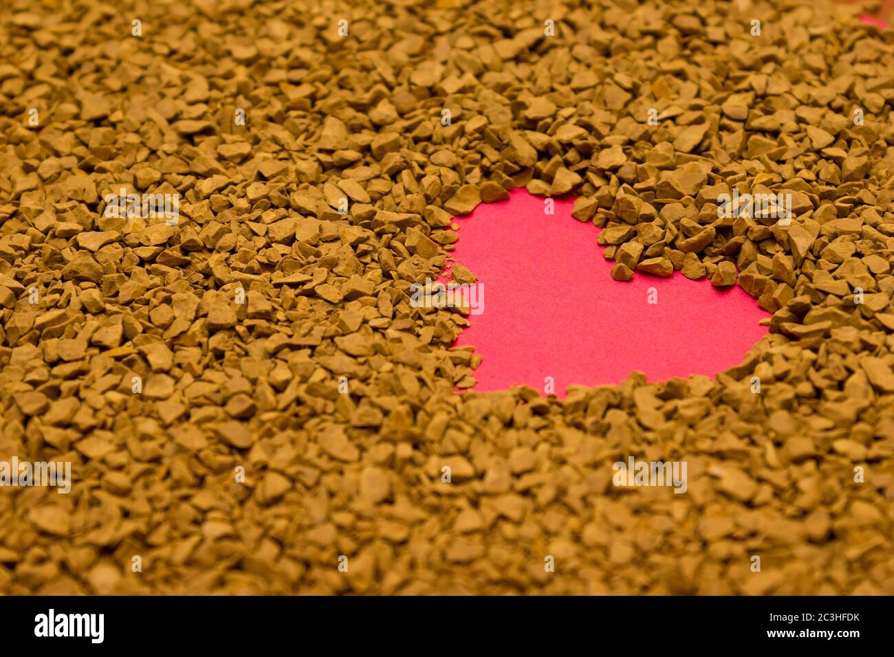 Dry instant coffee granules in the shape of a heart - brown texture ...