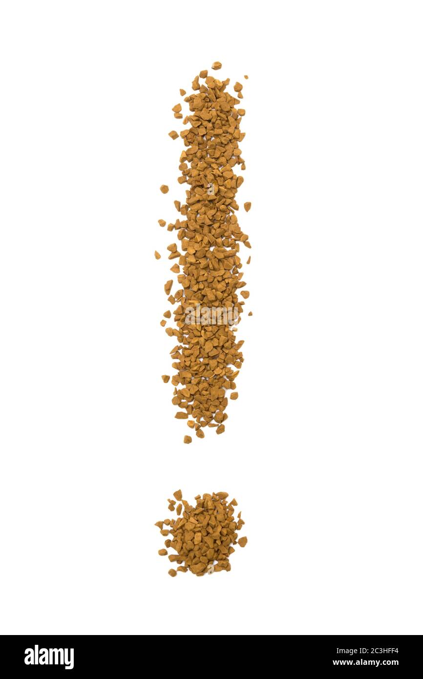 Dry granules of instant coffee in the shape of an exclamation mark ...
