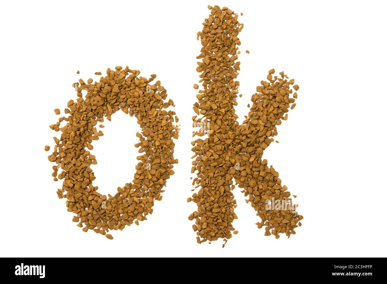Dry instant coffee granules in the shape of a ok sign - brown texture ...