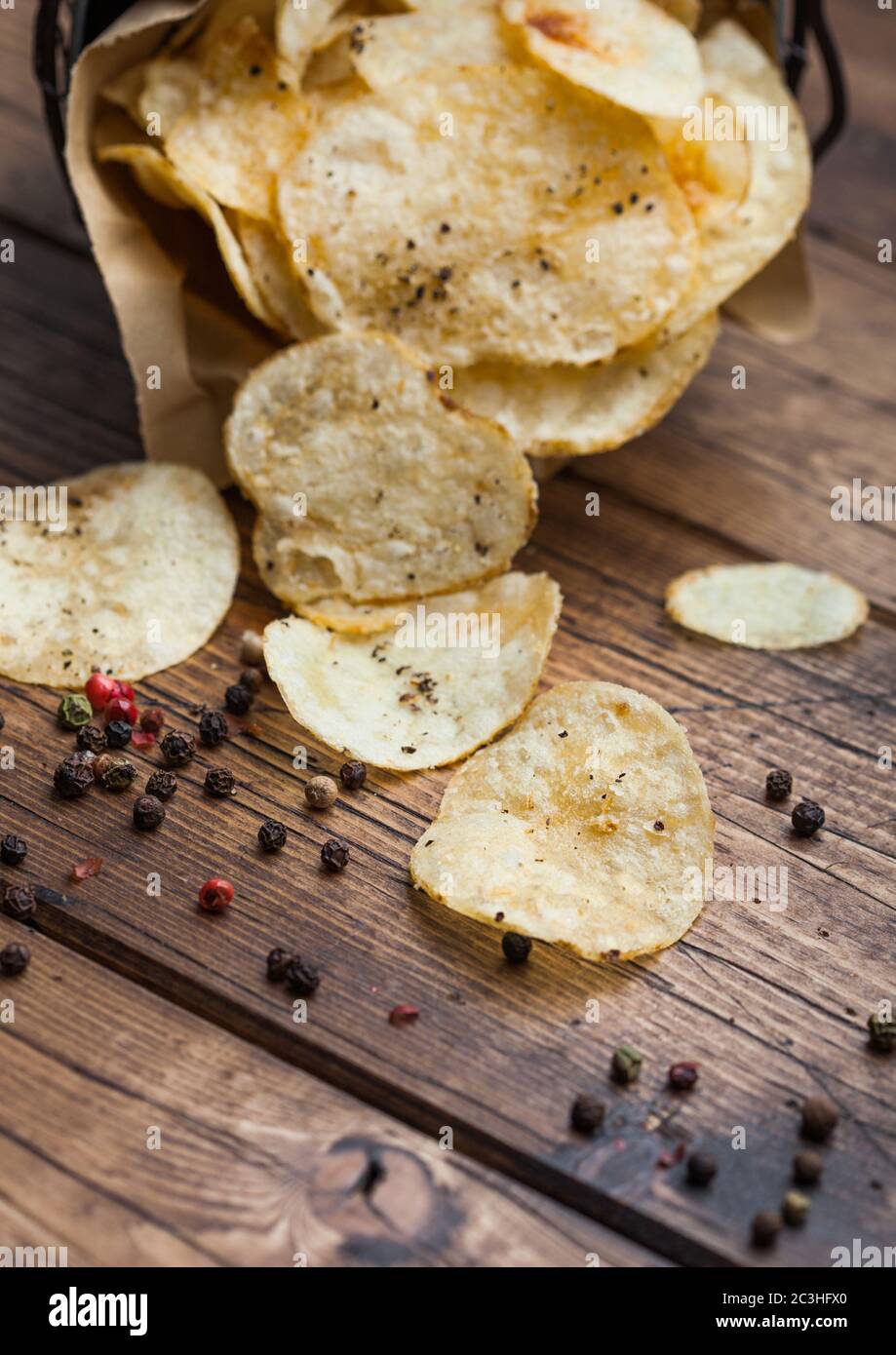 Crunchy potato crisps chips with black pepper in steel snack bucket on ...