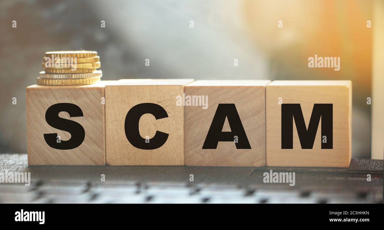 Word SCAM. Wooden small cubes with letters isolated on computer ...