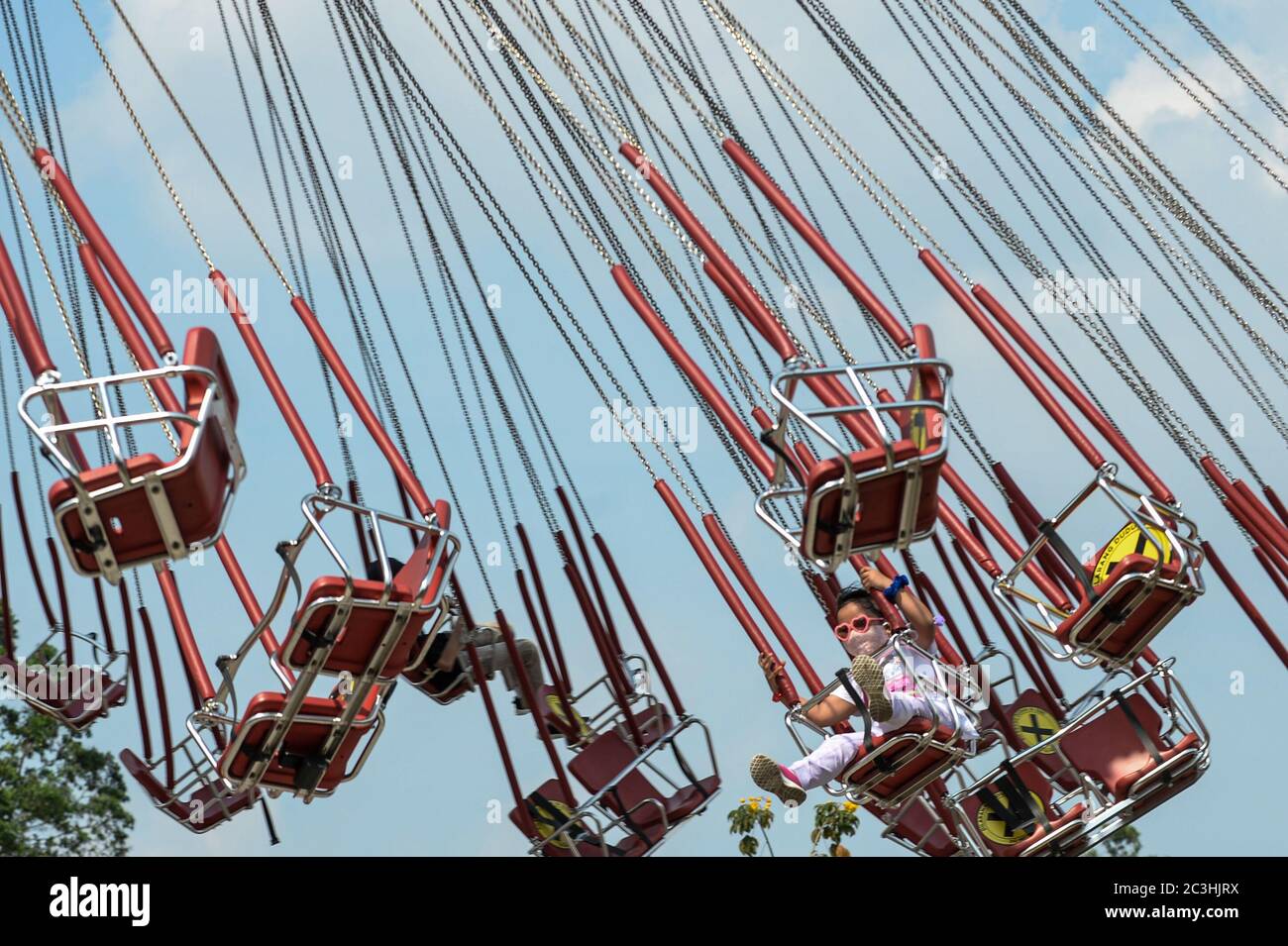 Jakarta, Indonesia. 20th June, 2020. A girl wearing a face mask has fun ...