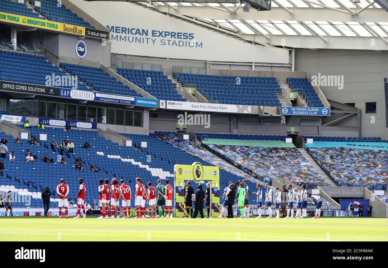 Teams line up in front of empty stands during the Premier League match ...