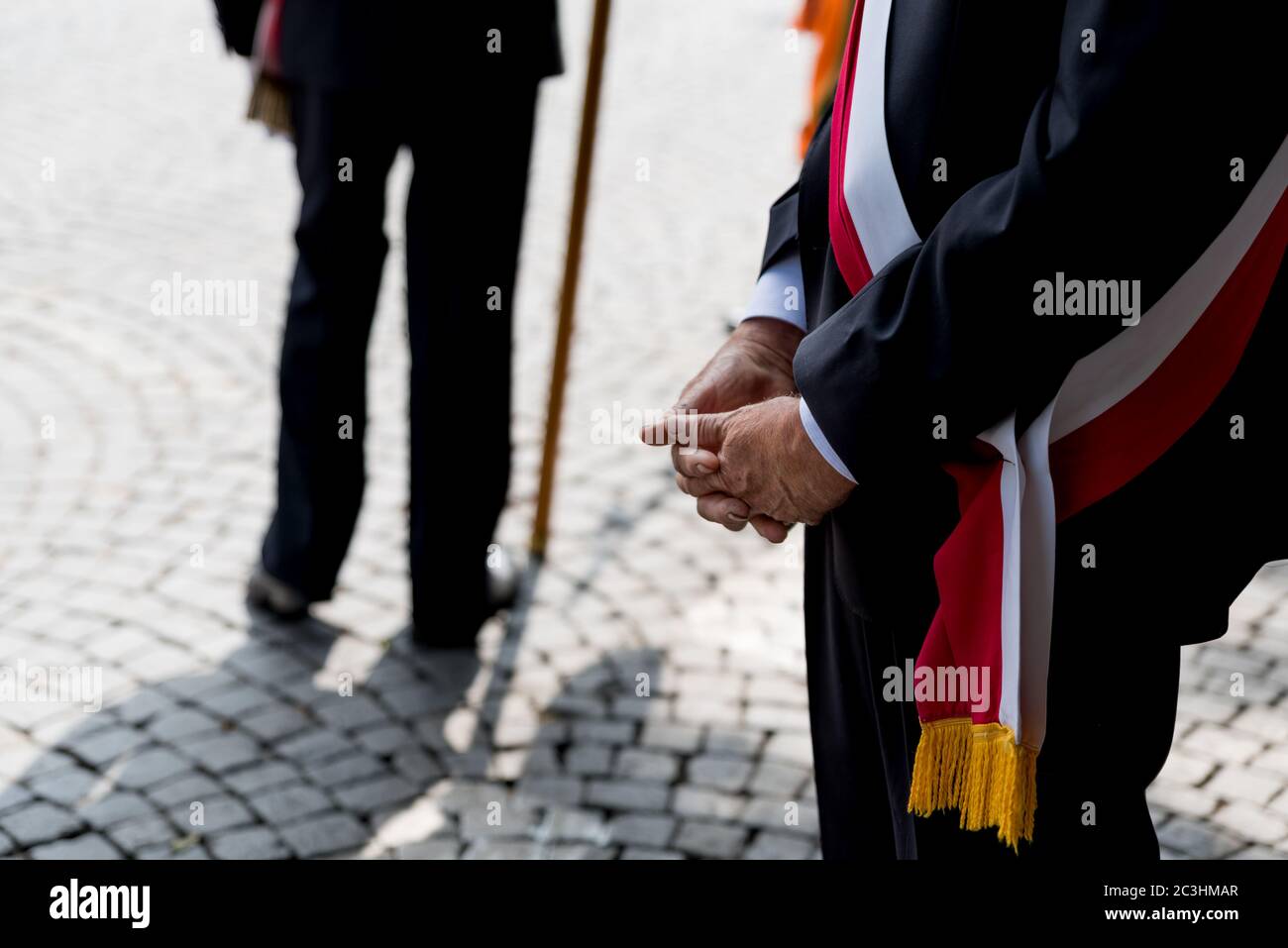Old man wearing black suit during religious ceremony in Poland. Polish ...