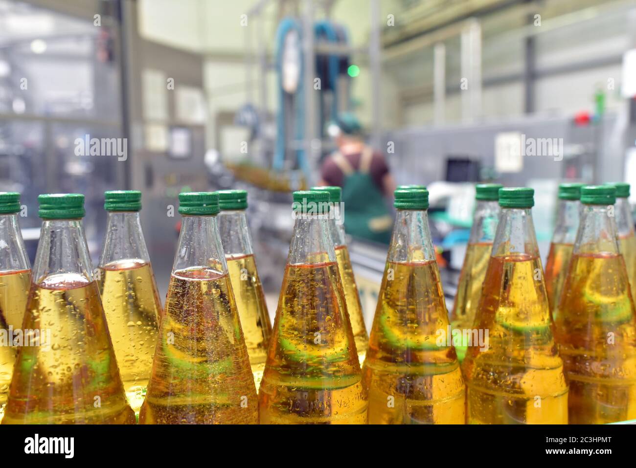 apple juice in glass bottles in a factory for the food industry ...