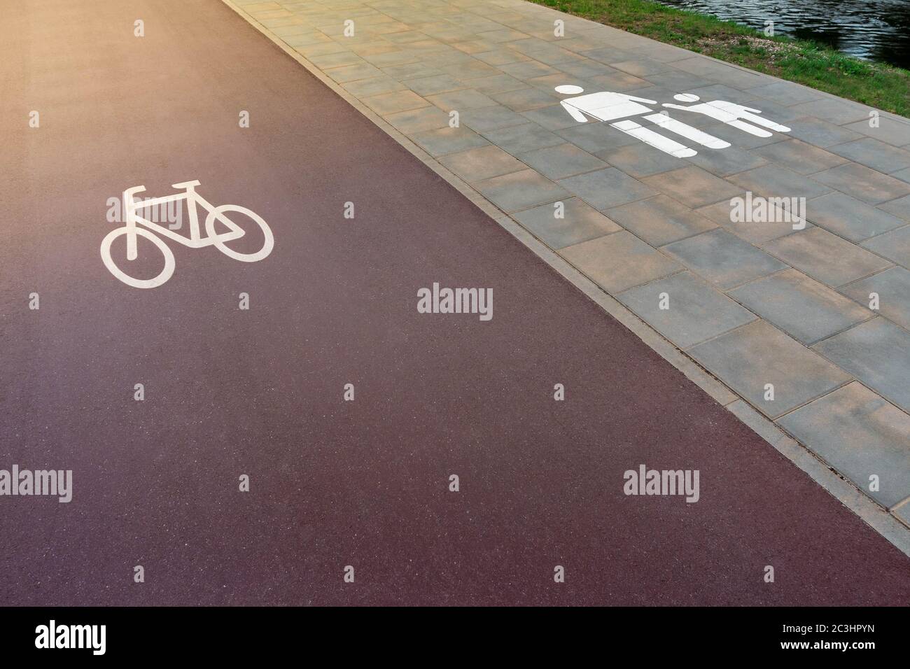 Traffic signs on bicycle path and sidewalk for pedestrians near river ...
