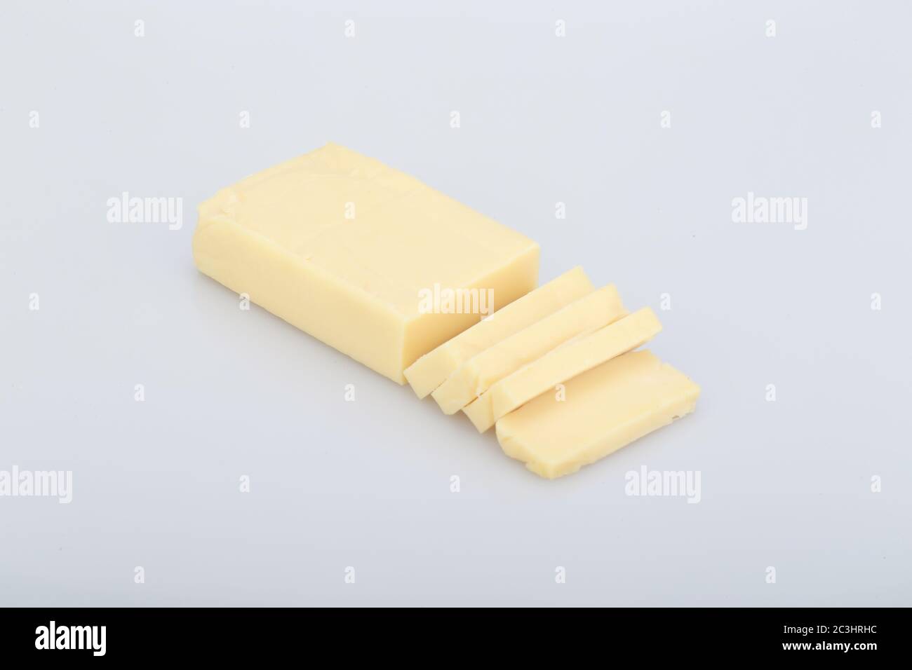 High angle shot of a piece of butter isolated on a white background ...