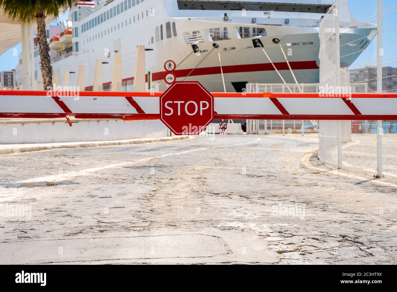 Stop sign in barrier. Closed access for the ship in the port. Travel ...