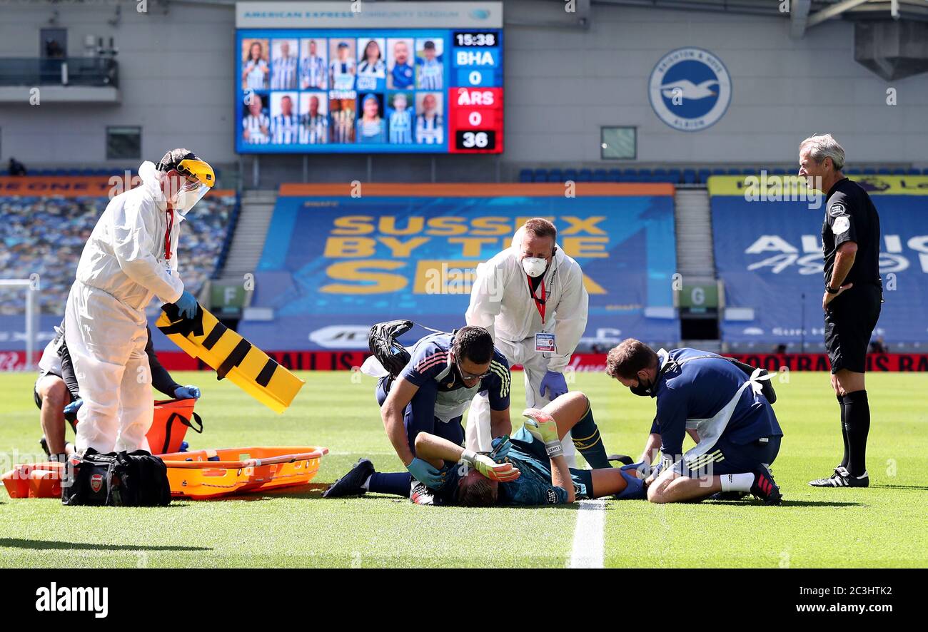 Arsenal goalkeeper Bernd Leno receives treatment on the pitch after ...