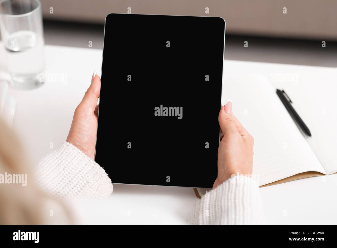 Online education and webinar viewing. Female hands holding tablet with ...