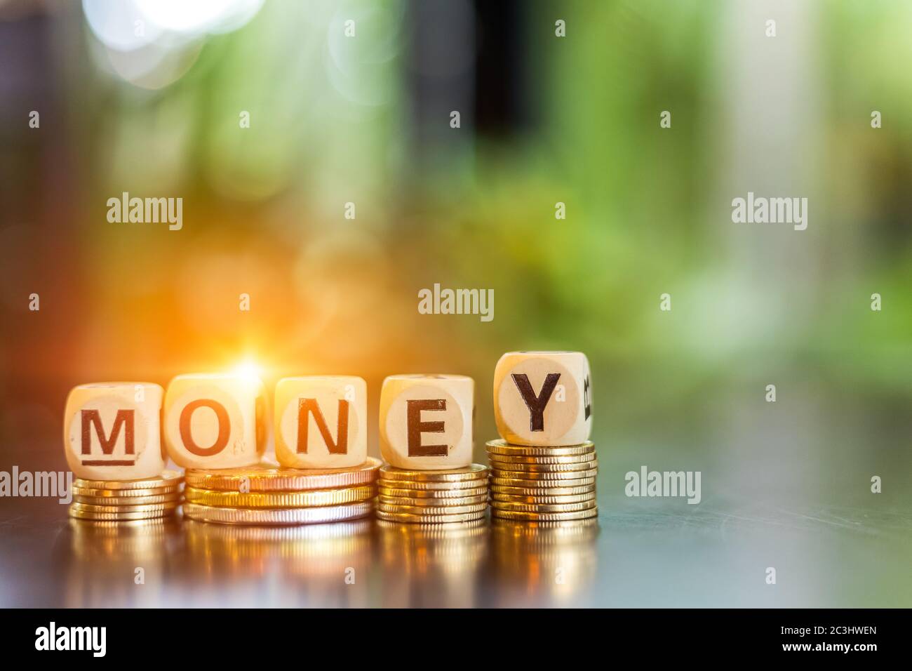 wood cube word "money" on coin Stock Photo - Alamy
