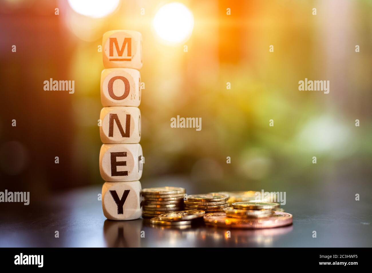 wood cube word "money" near gold coin on the table Stock Photo - Alamy