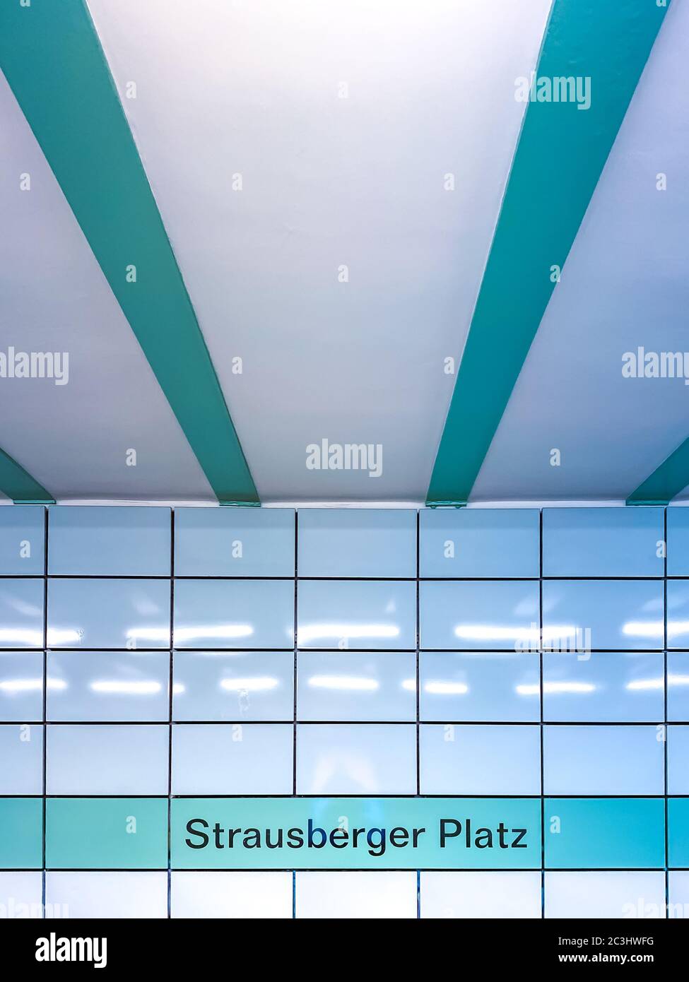Vertical shot of a reflective wall with ceramic tiles and a black ...