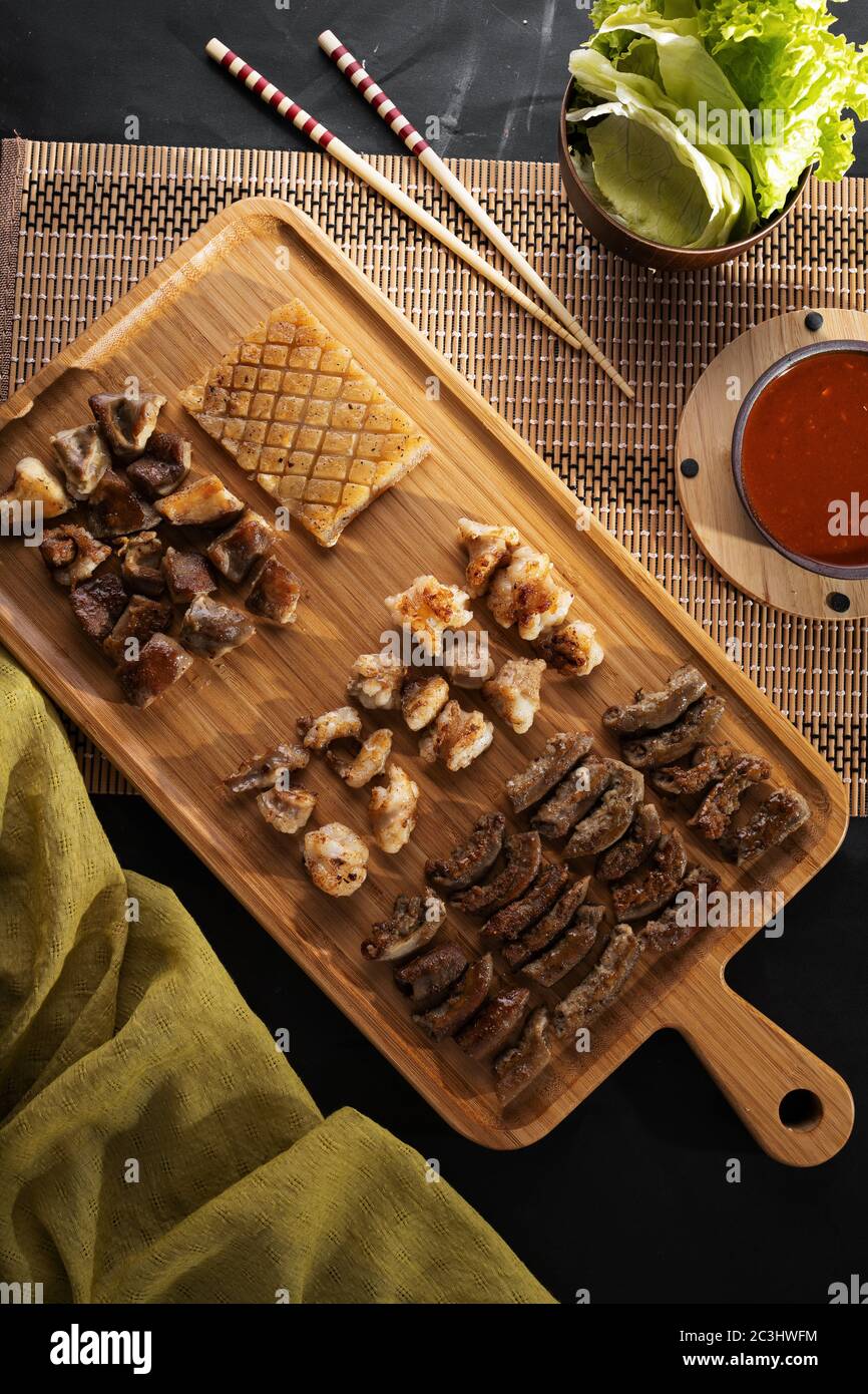 Vertical high angle shot of a wooden plate filled with roasted food on ...