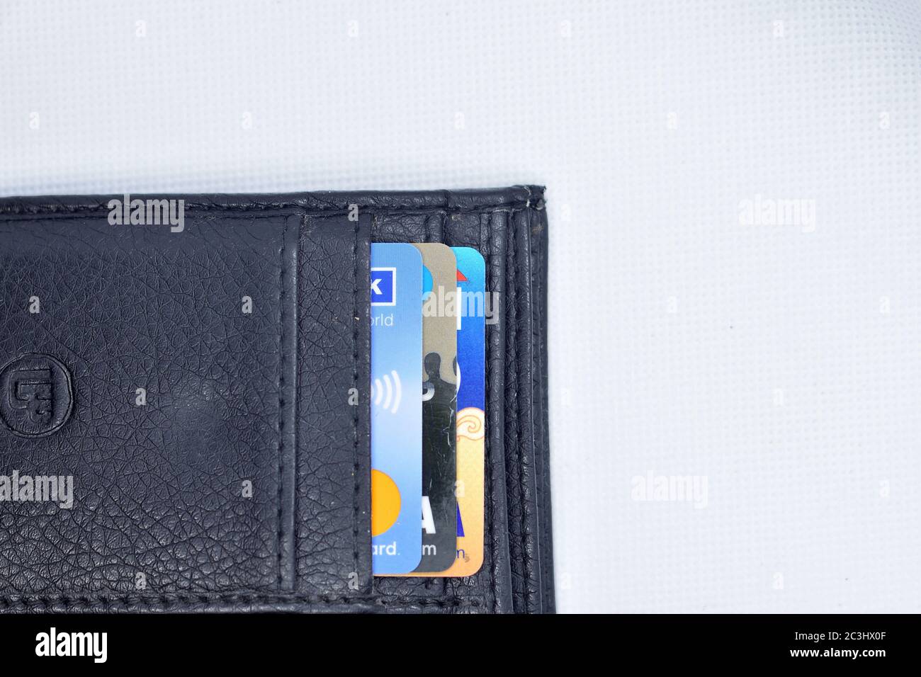 Debit and Credit cards in black color wallet on white background. Top ...