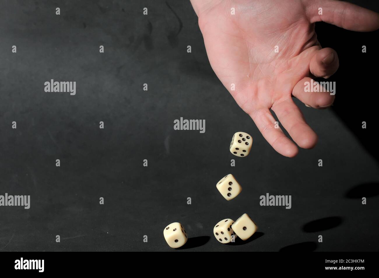An Hand Play Dice on a Dark Background Stock Photo - Alamy