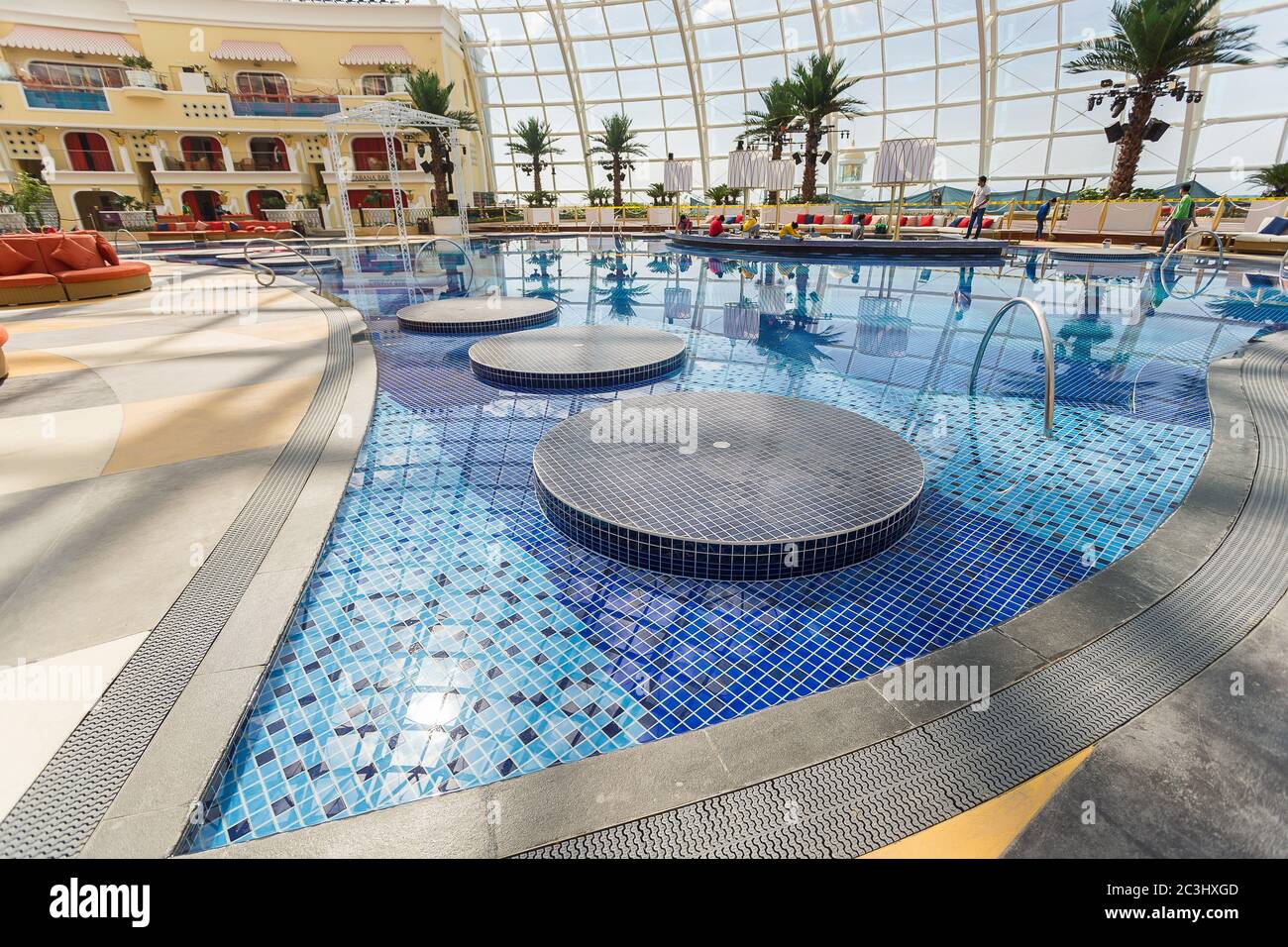 Shot of an indoor swimming pool designed with ceramic tiles in shades ...