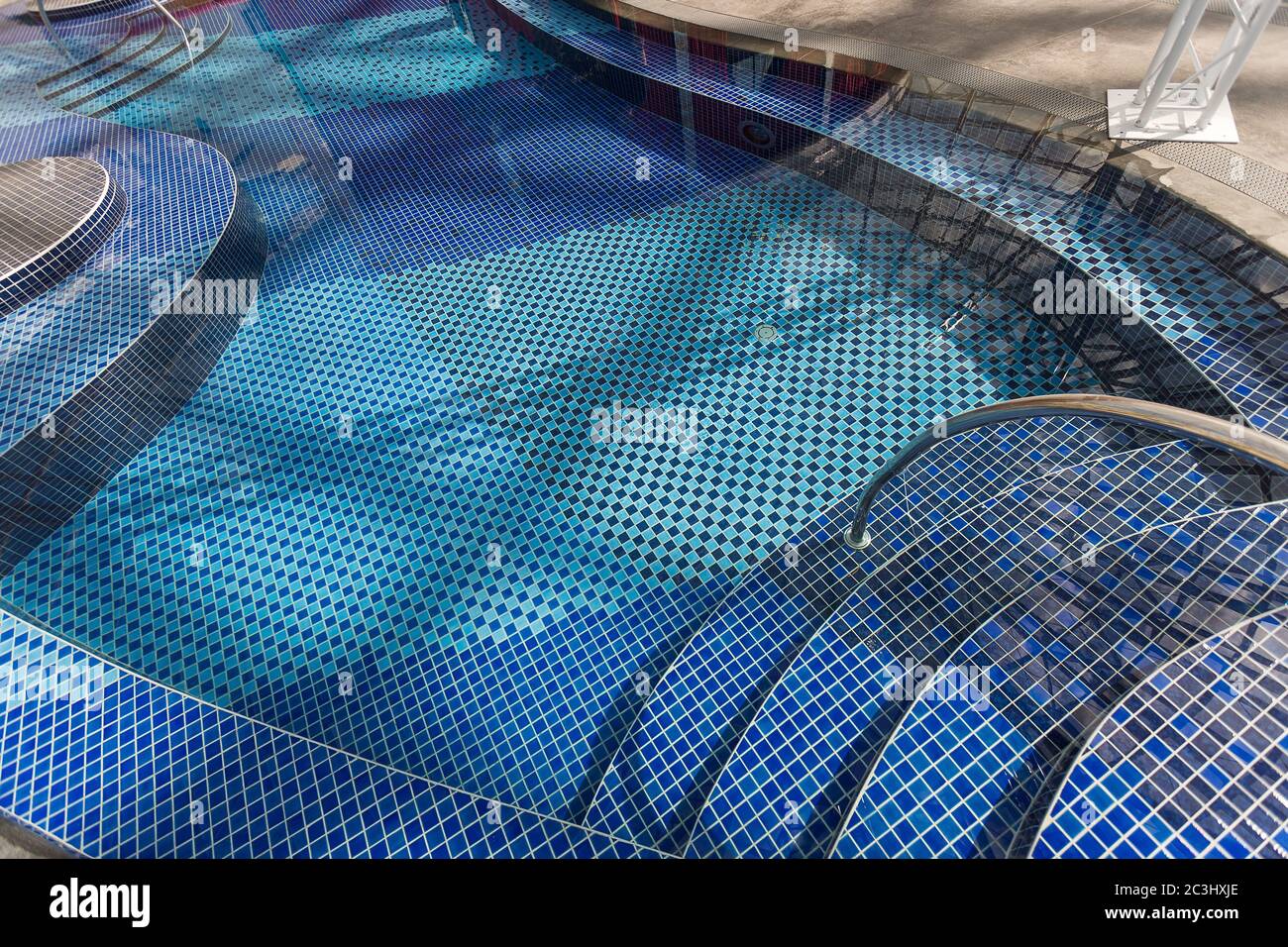 Shot of an indoor swimming pool designed with ceramic tiles in shades ...