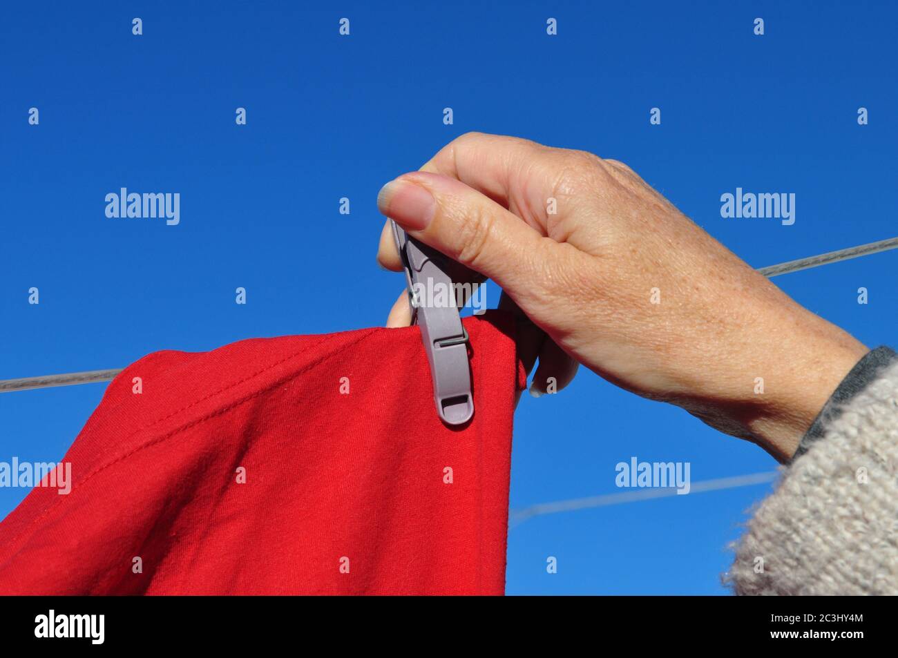 Woman hanging washing outside hi-res stock photography and images - Alamy