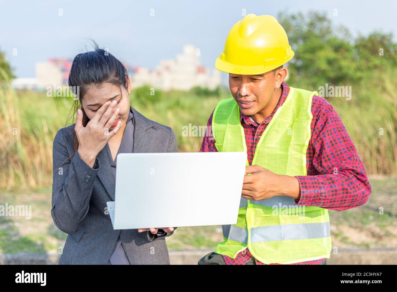 Businesswomen and foreman talking together and happy funny. Engineer ...
