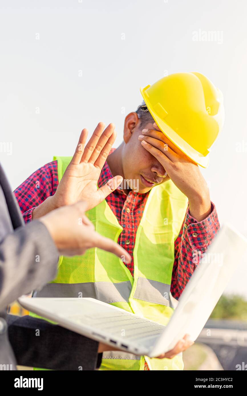 A man raise hands up for stop and give up. Foreman afraid manager at ...