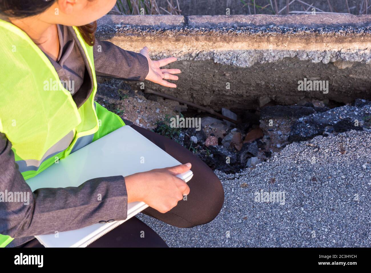 Engineer checking and showing damaged road asphalt concrete design ...