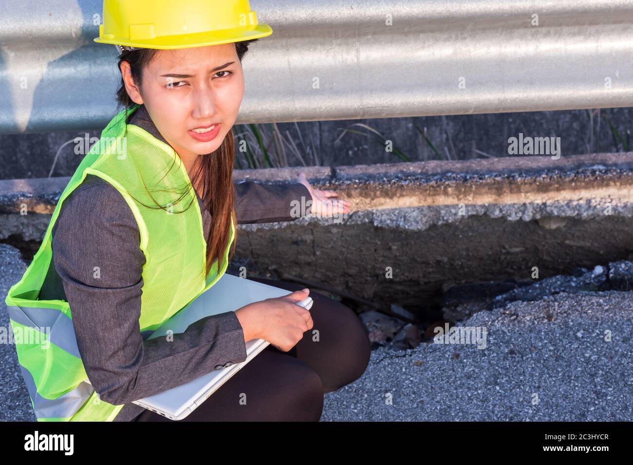 Engineer checking and showing damaged road asphalt concrete design ...