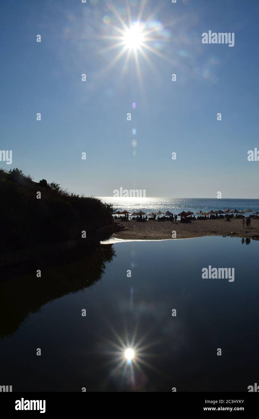 Sun reflection on the beach. Geger Beach is located in Sawangan, about ...